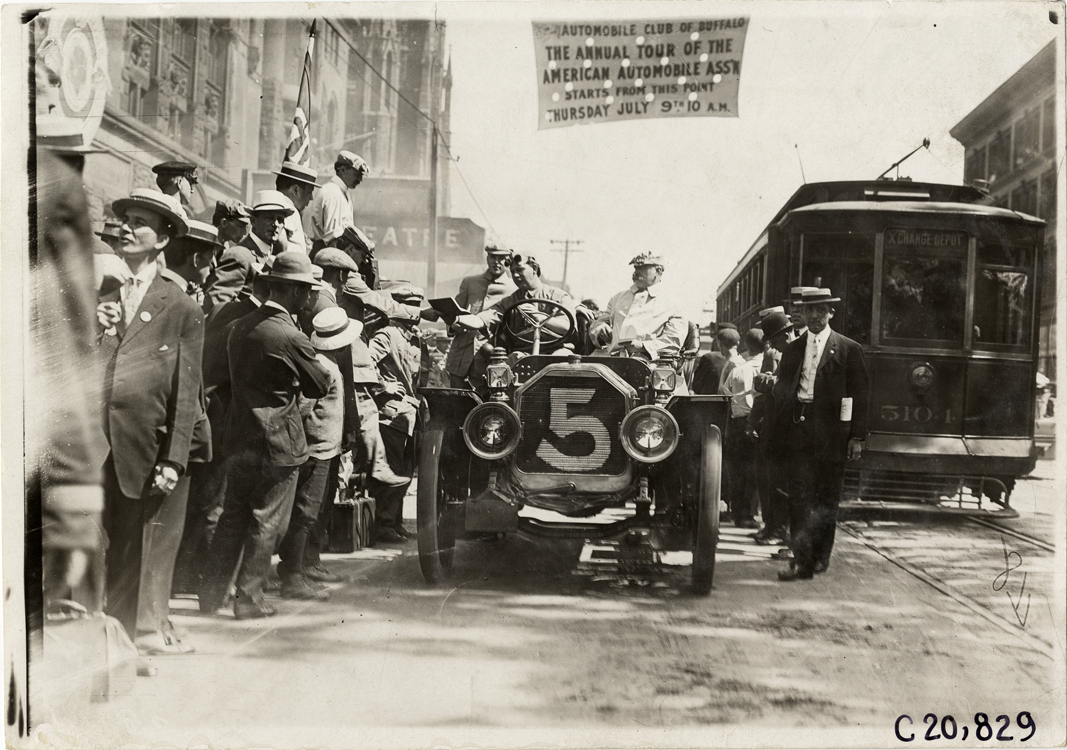 Spectators surrounding motorists in Peerless automobile in front of ...