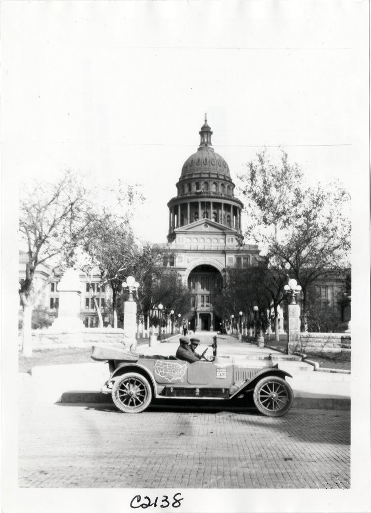 Motorists posing in Hupmobile automobile in front of Texas state ...