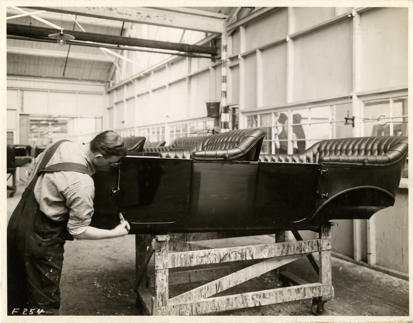 Worker assembling automobile body, Willys-Overland Company factory ...