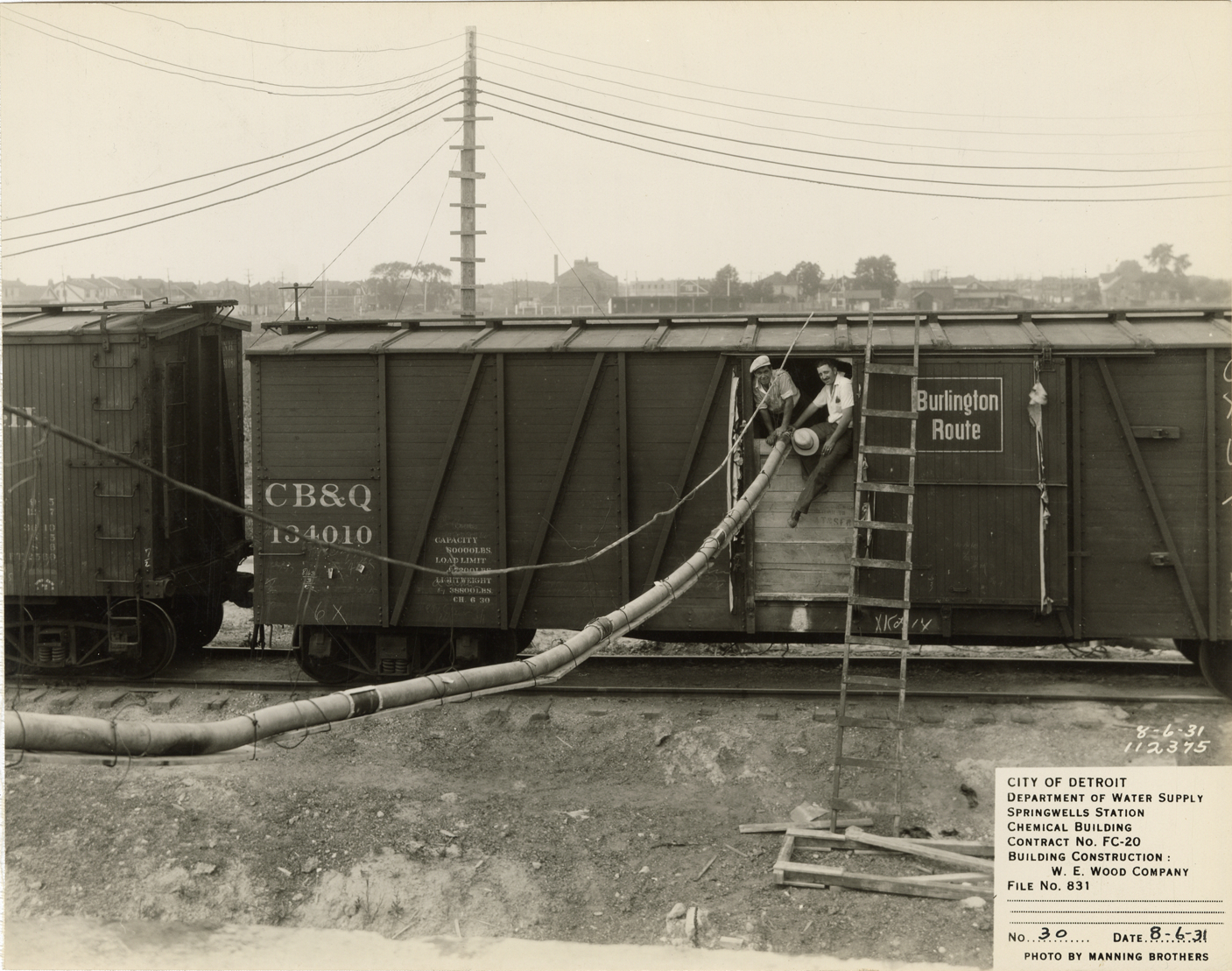Men unloading alum from freight car, Springwells Station treatment ...
