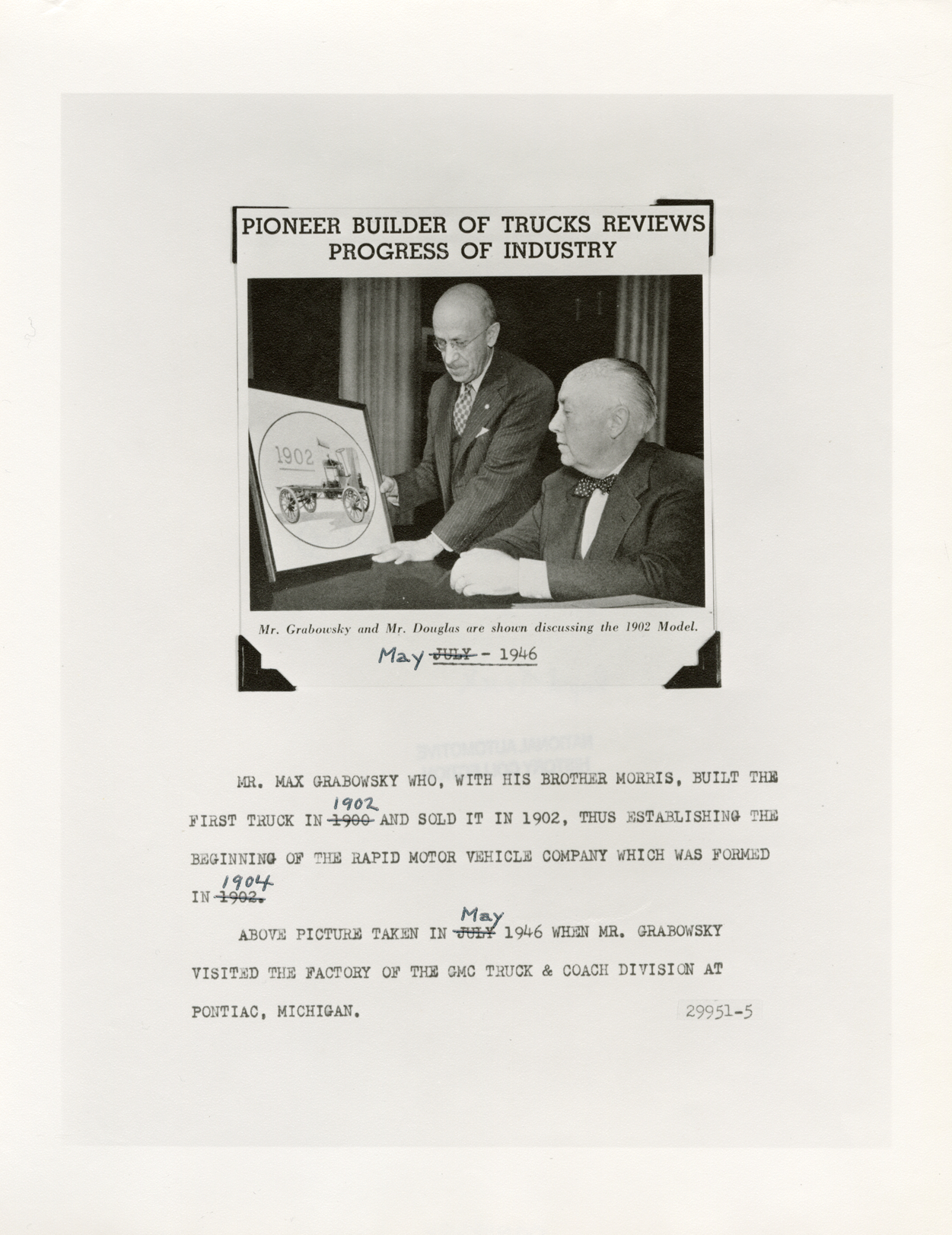 Max Grabowsky and Mr. Douglas posing with photograph of 1902 Rapid ...